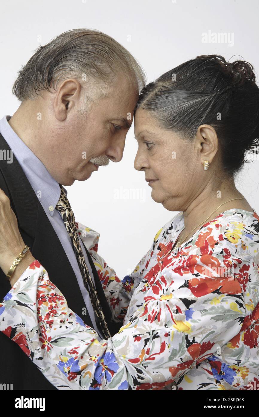 Old couple, old woman touching forehead on old man concerned look MR ...