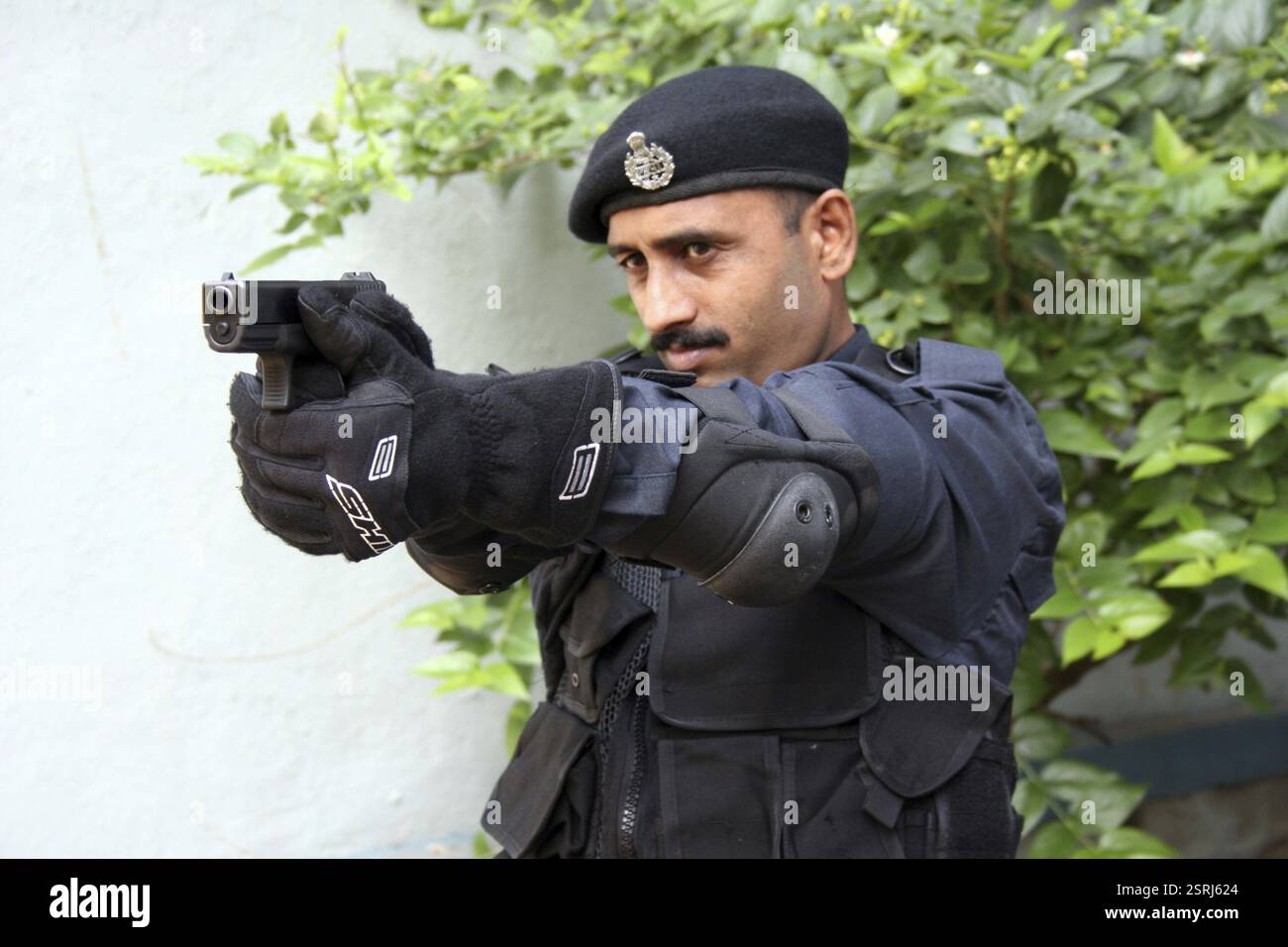 Black Cat commando with a revolver, Glock MR Stock Photo - Alamy