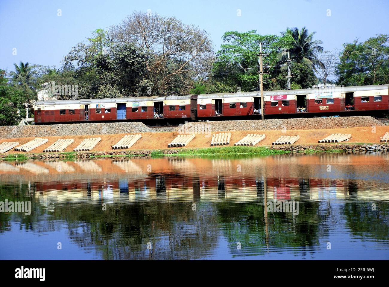 E.M.U local train reflection in pond, Calcutta Kolkata, West Bengal ...