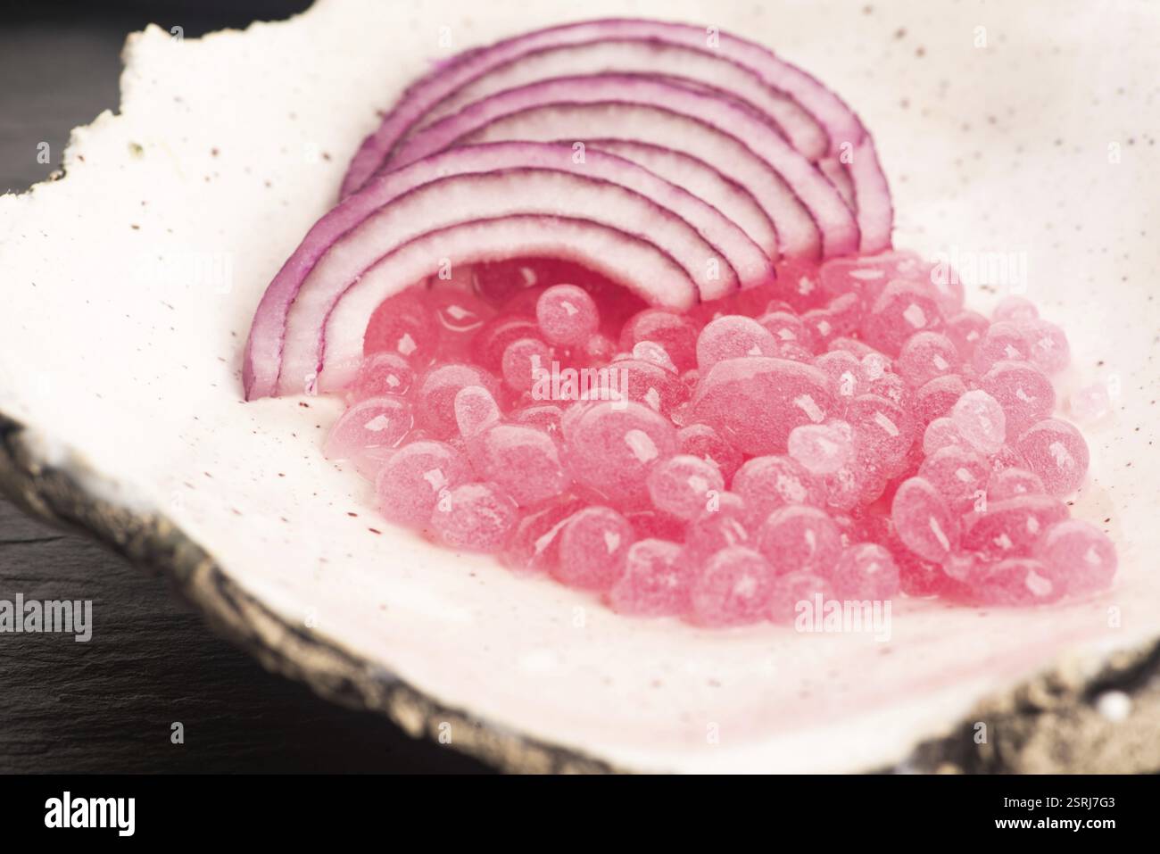 Molecular onion caviar balls on ceramics plate Stock Photo - Alamy