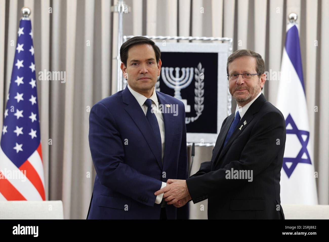 U.S. Secretary of State Marco Rubio, left, shakes hands with Israeli ...