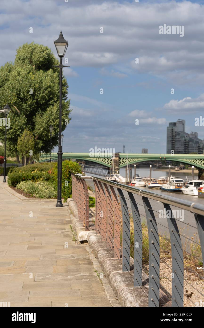 River Thames path, London. Metal railing overlooks moored boats Stock ...