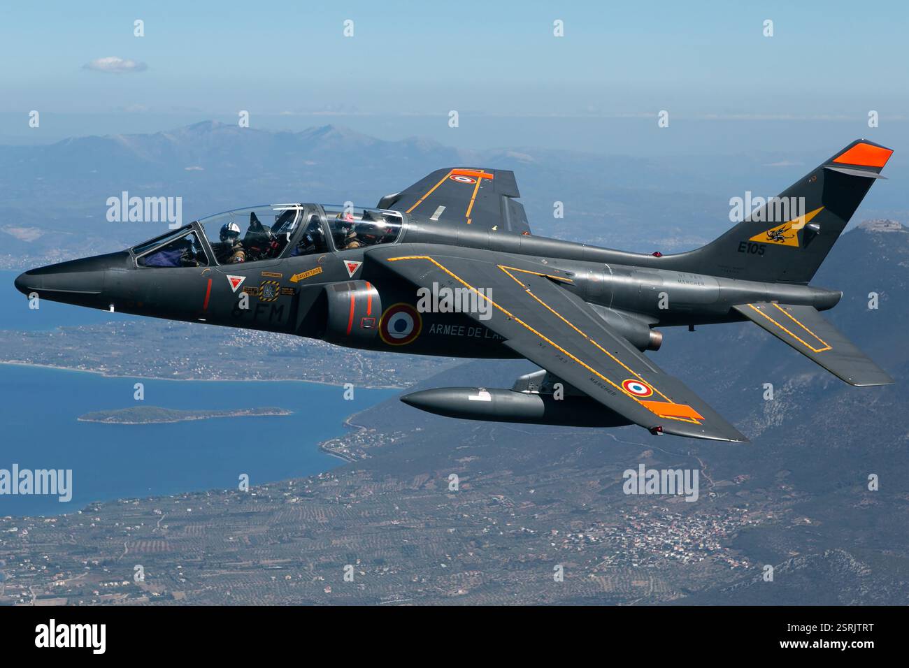 French Air Force Alpha Jet performing aerobatic maneuvers. A light ...