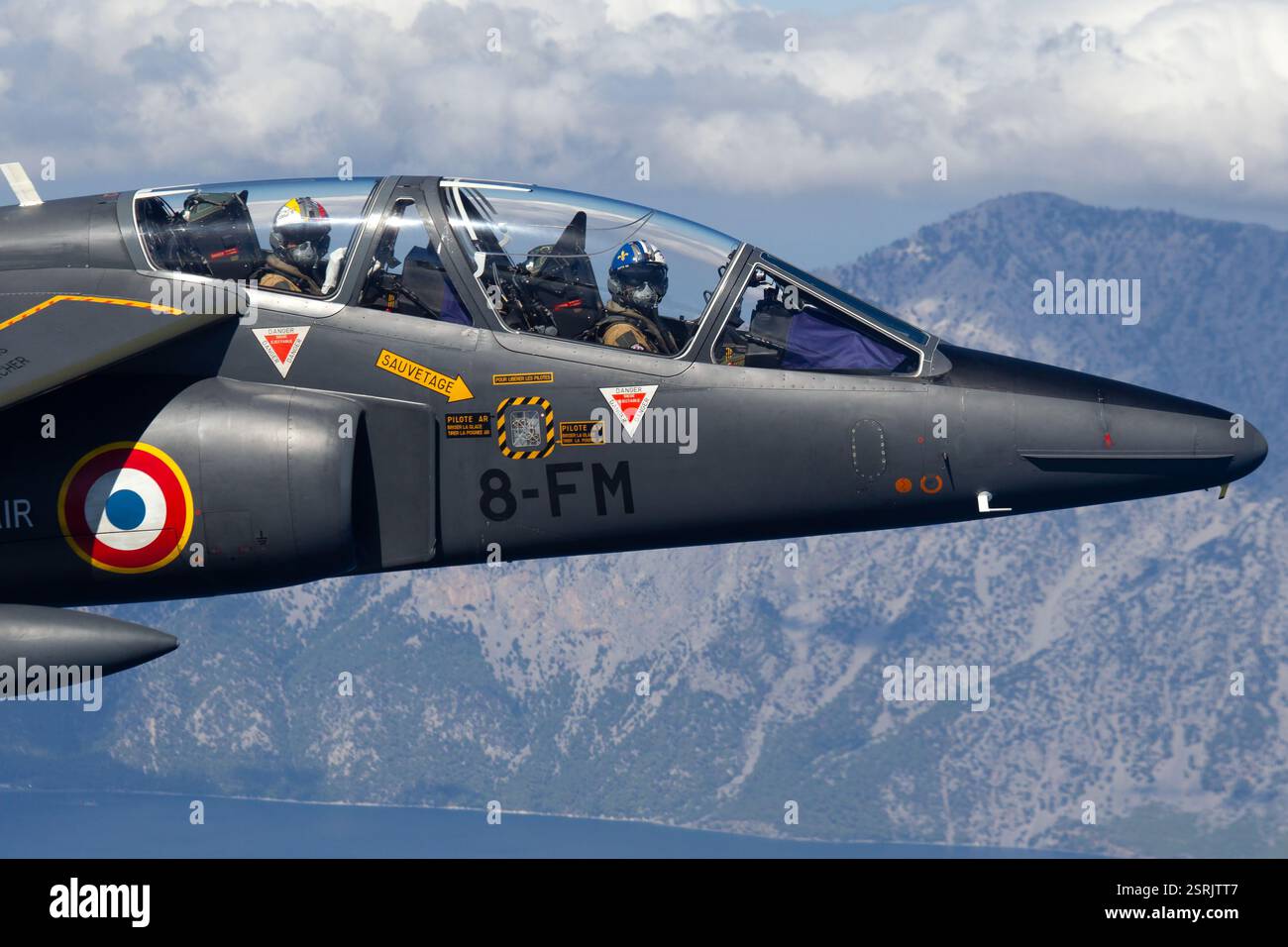 French Air Force Alpha Jet performing aerobatic maneuvers. A light ...