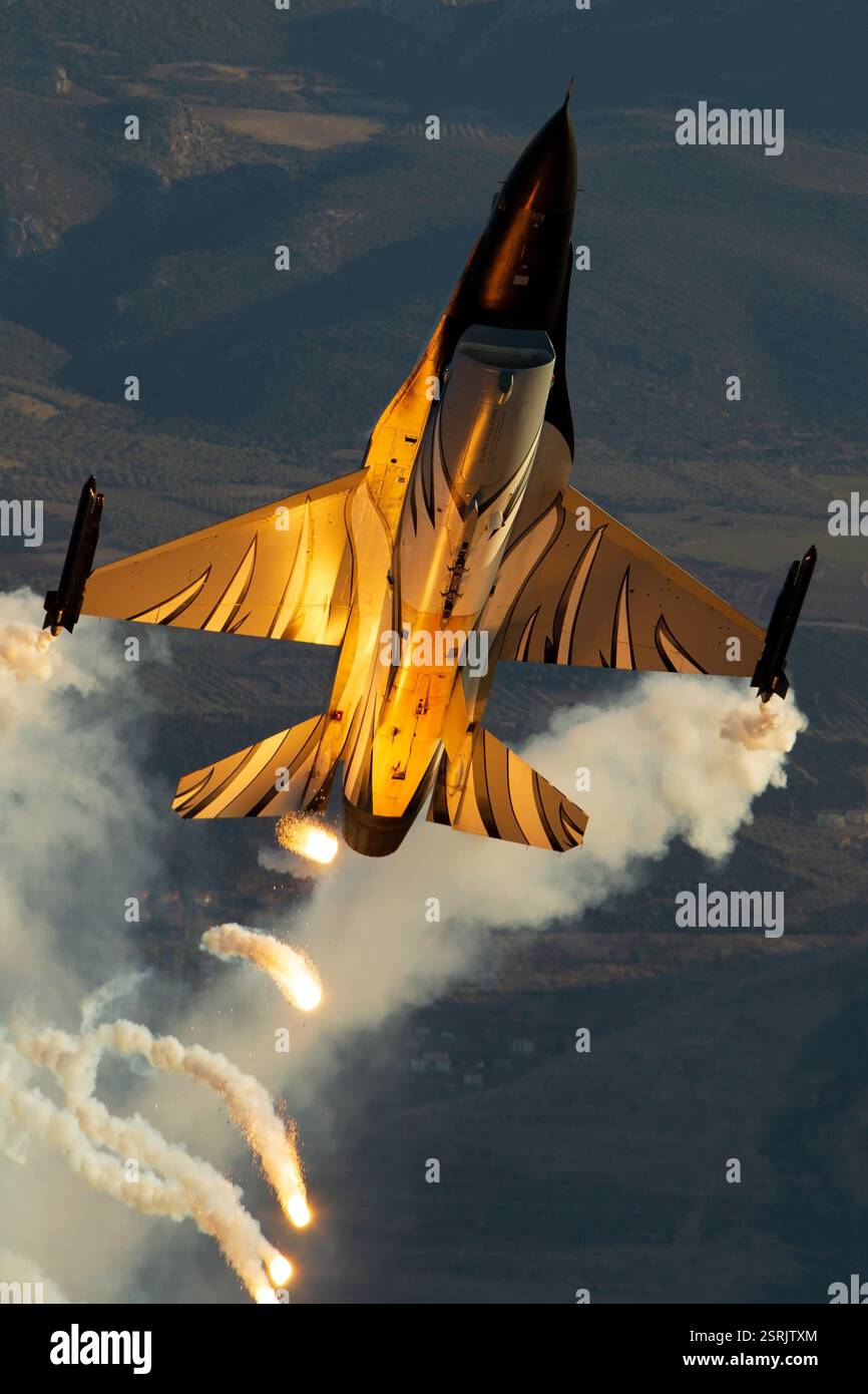 Belgian Air Force F-16 releasing flares during a tactical maneuver. A ...