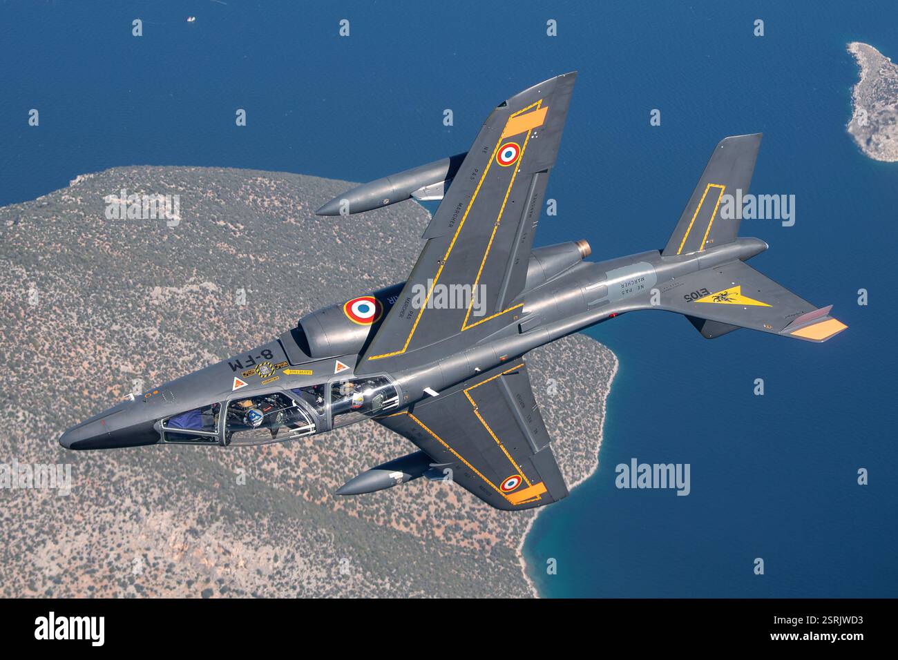 French Air Force Alpha Jet performing aerobatic maneuvers. A light ...