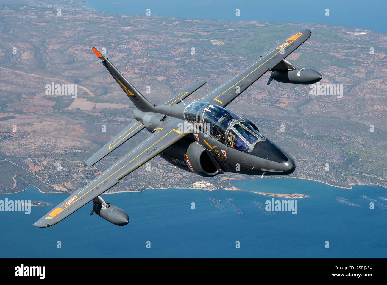 French Air Force Alpha Jet performing aerobatic maneuvers. A light ...