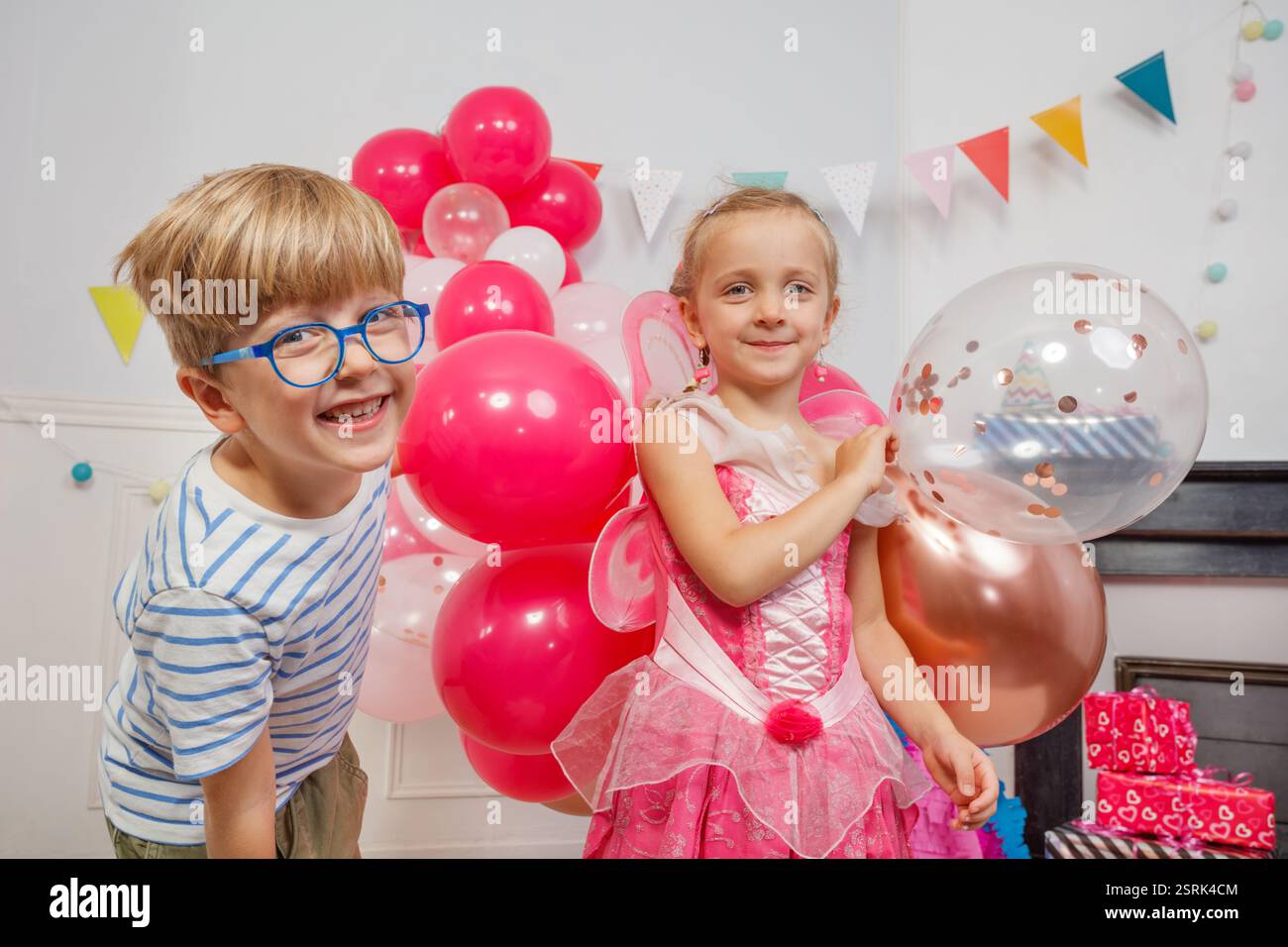 Two children dance, celebrating with vibrant balloons and smile Stock ...