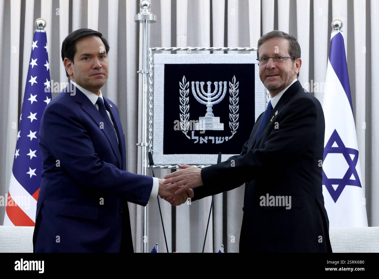 U.S. Secretary of State Marco Rubio, left, shakes hands with Israeli ...