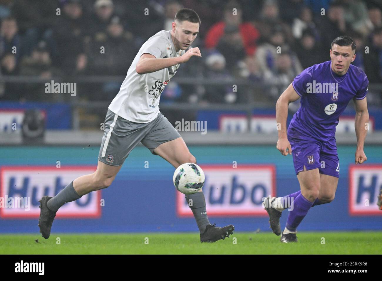 Anderlecht, Belgium. 27th Dec, 2024. Aurelien Scheidler (11) of Dender and Jan-Carlo Simic (4 ...