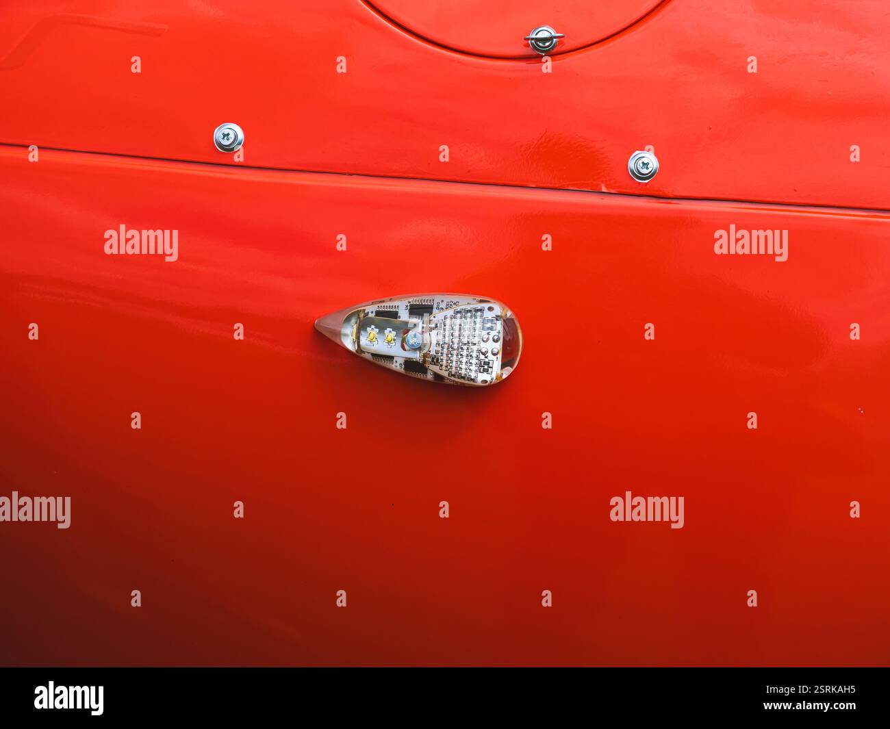 Detailed view of a red aircraft fuselage featuring an LED navigation ...