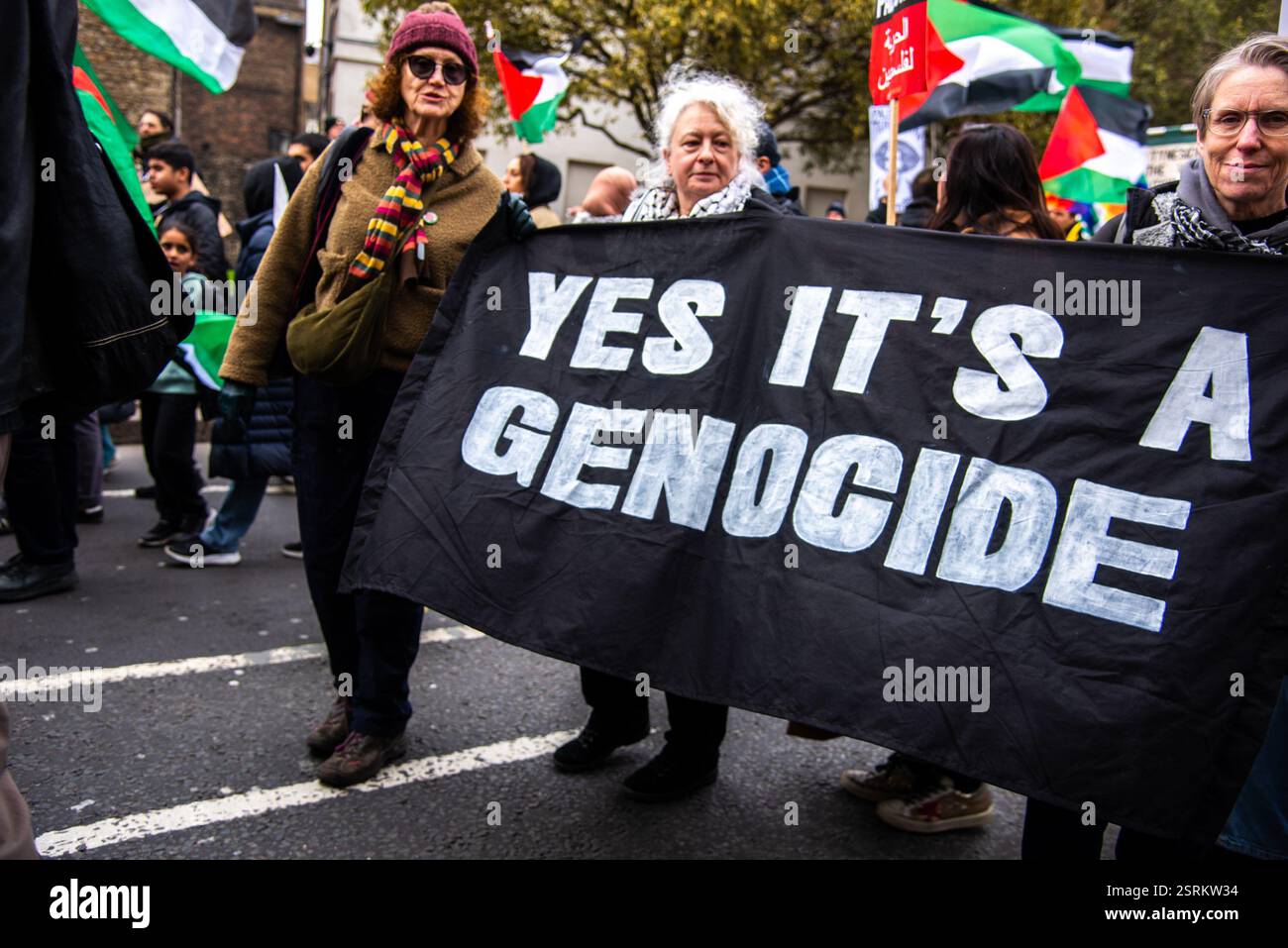 Protestors march with a large banner during the National march for ...