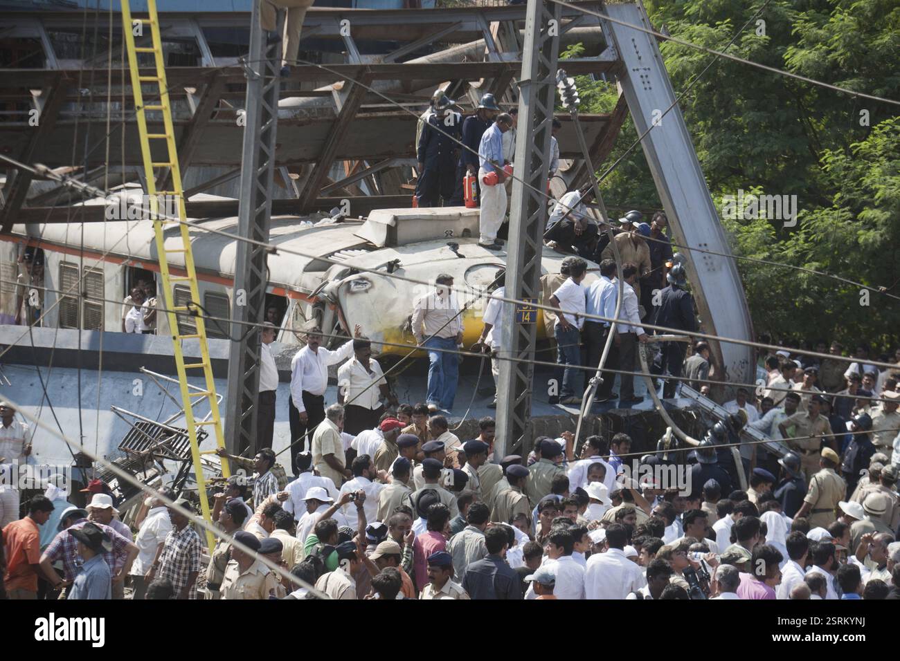 People gather during water pipeline collapsed over moving train, thane ...