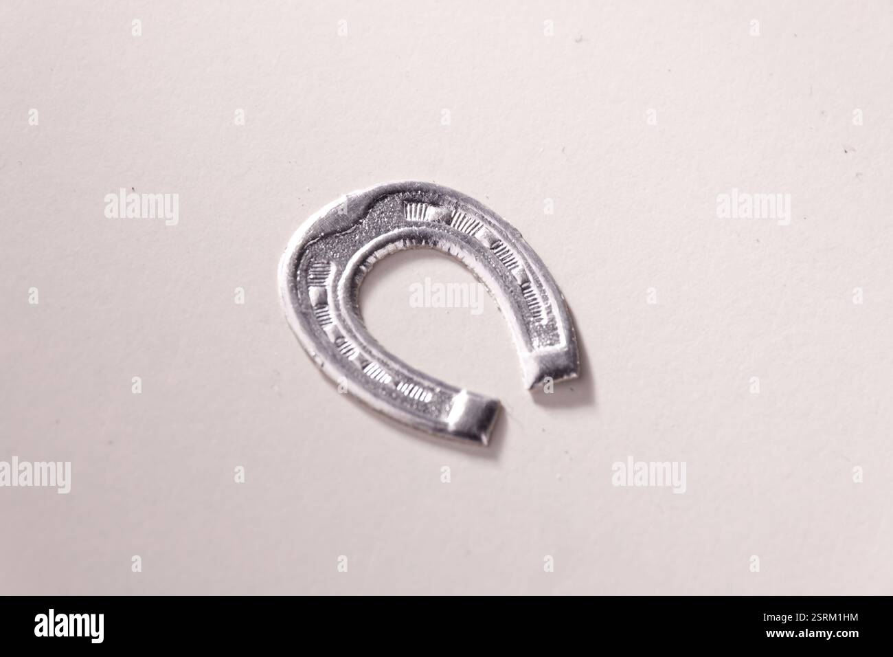View of a three-dimensional horseshoe with a silver metallic appearance ...