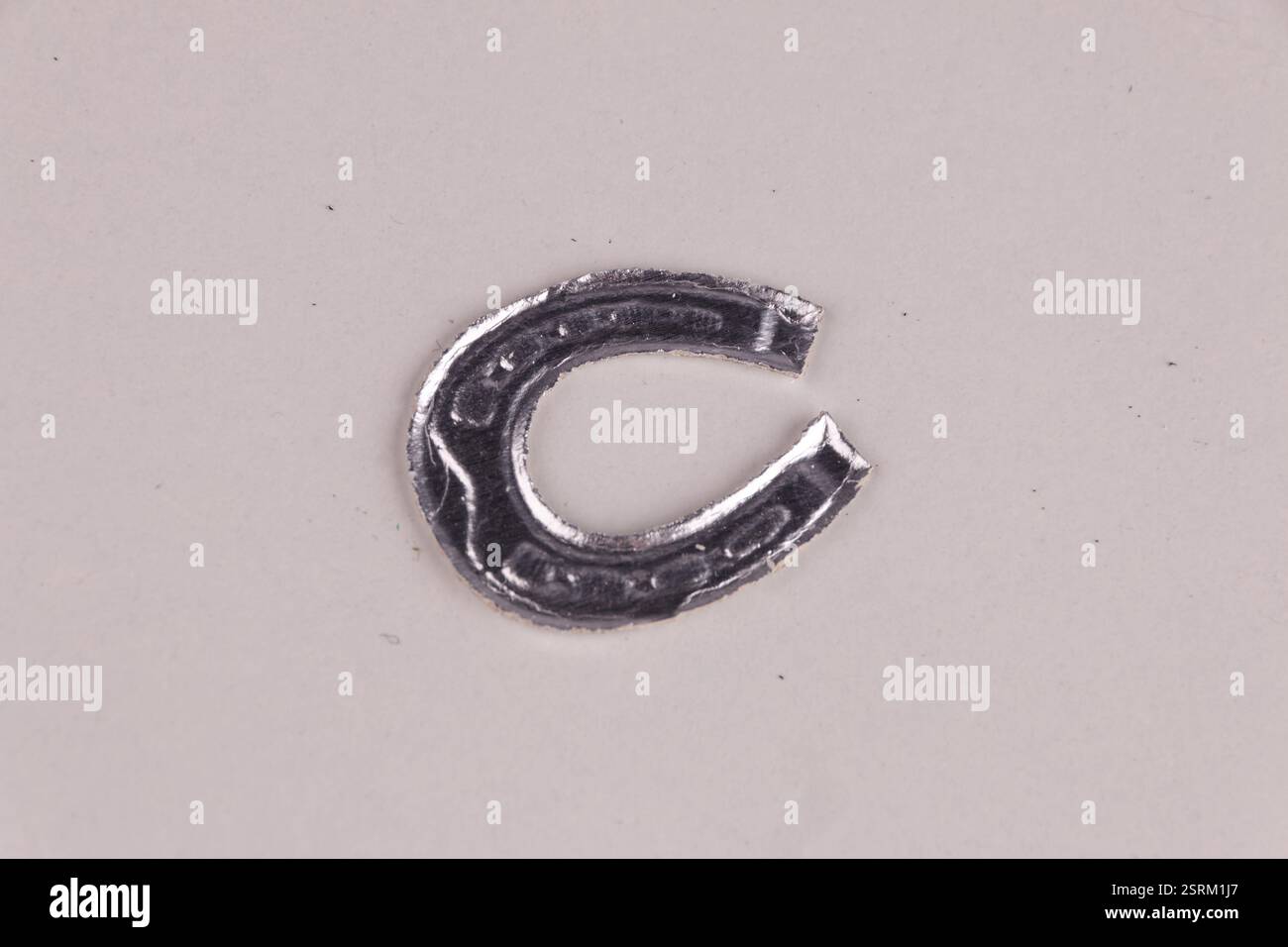 View of a three-dimensional horseshoe with a silver metallic appearance ...