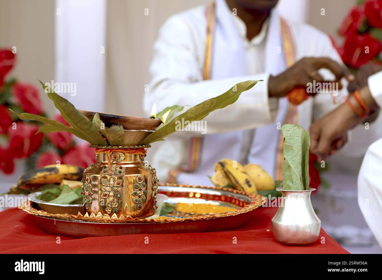 Decorative copper vessel with mango leaves offering to lord Wedding ...