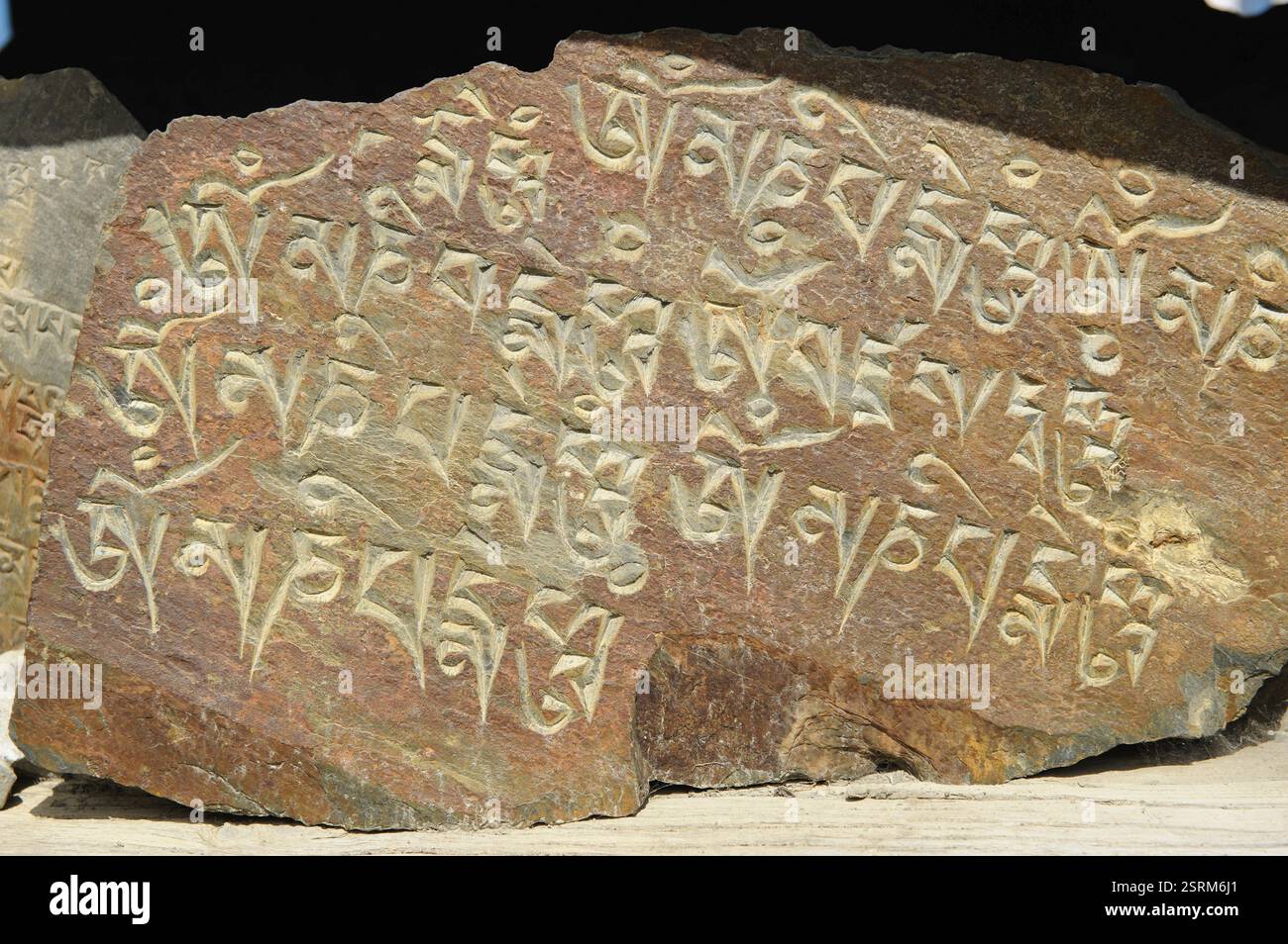 Stone engraved with buddhist mantra at dhukur pokhari pisang, Nepal ...
