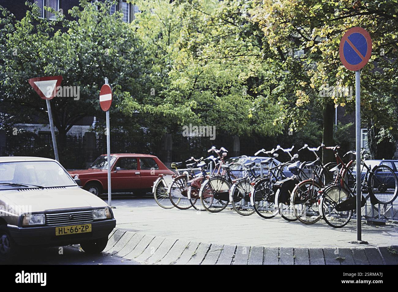 Bicycles parked, car on street with road signs, Amsterdam, Netherlands ...