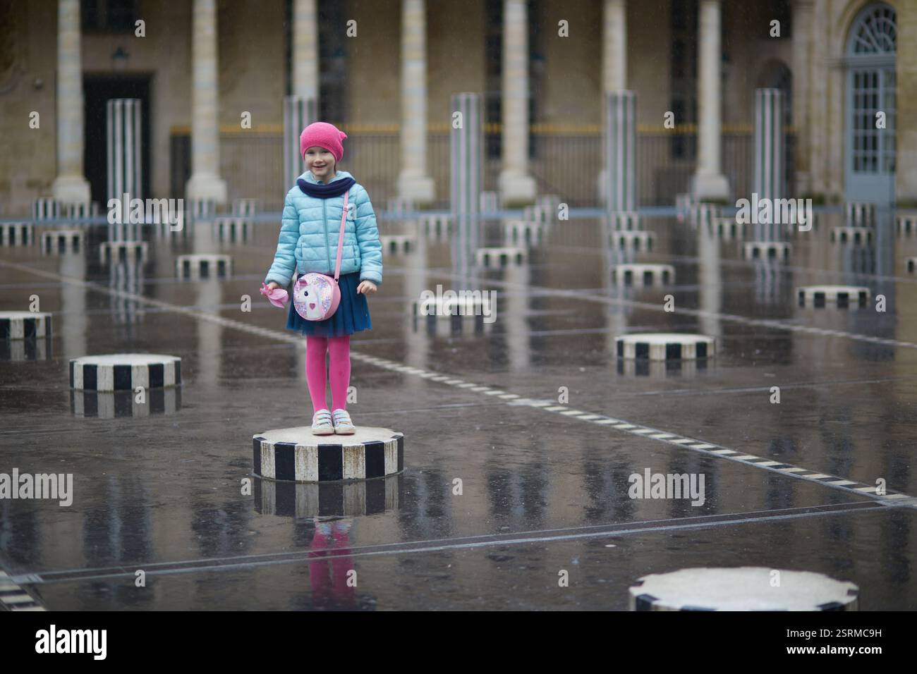 Adorable preschooler girl playing in Palais Royal garden. Child having ...