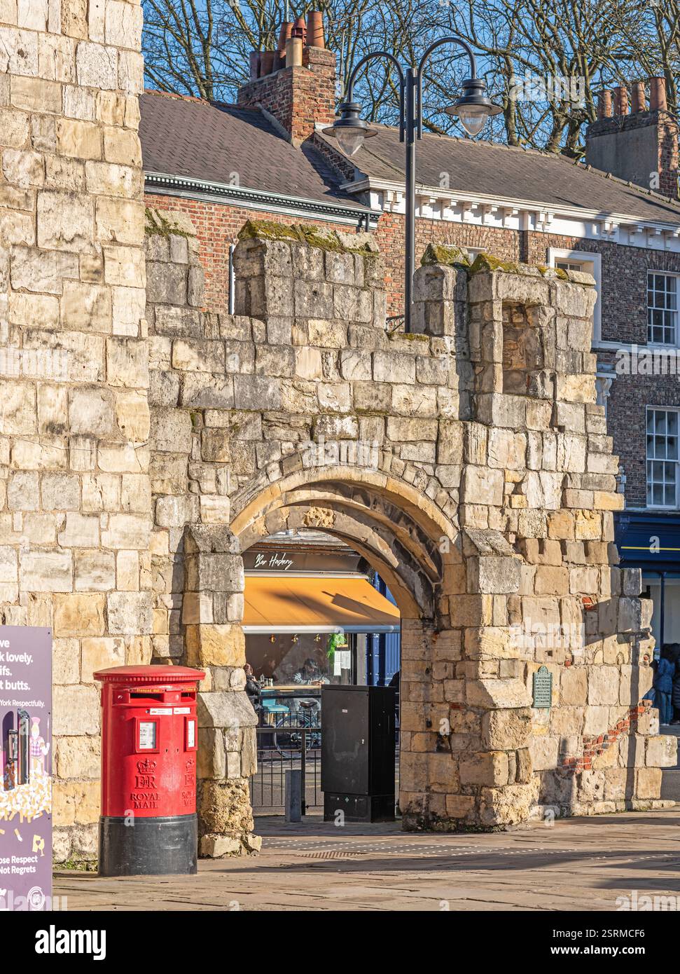 A section of the old city wall in York with an arched gateway. A ...