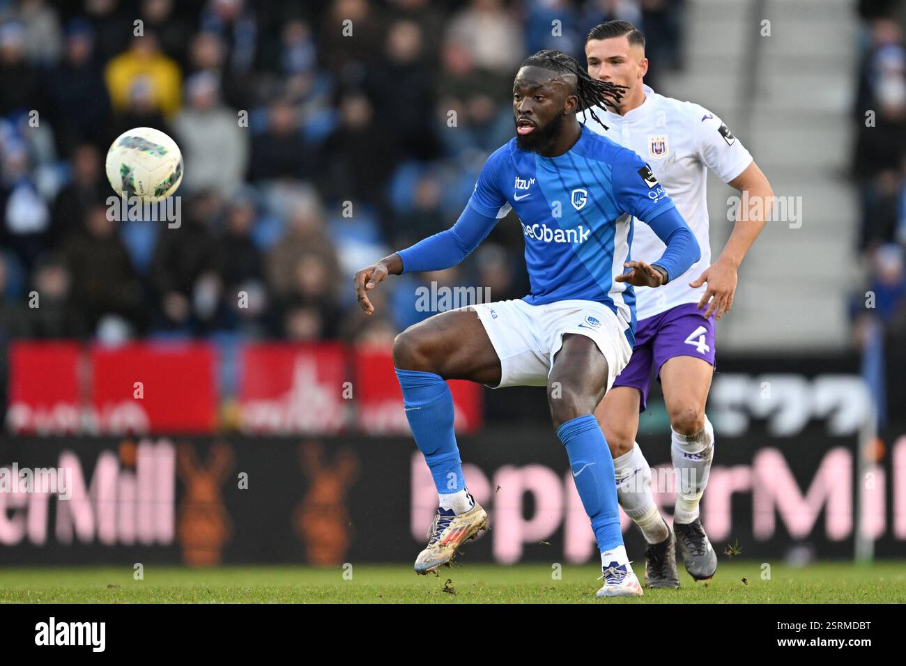 Genk, Belgium. 22nd Dec, 2024. Tolu Arokodare (99) of Genk and Jan-Carlo Simic (4) of Anderlecht ...