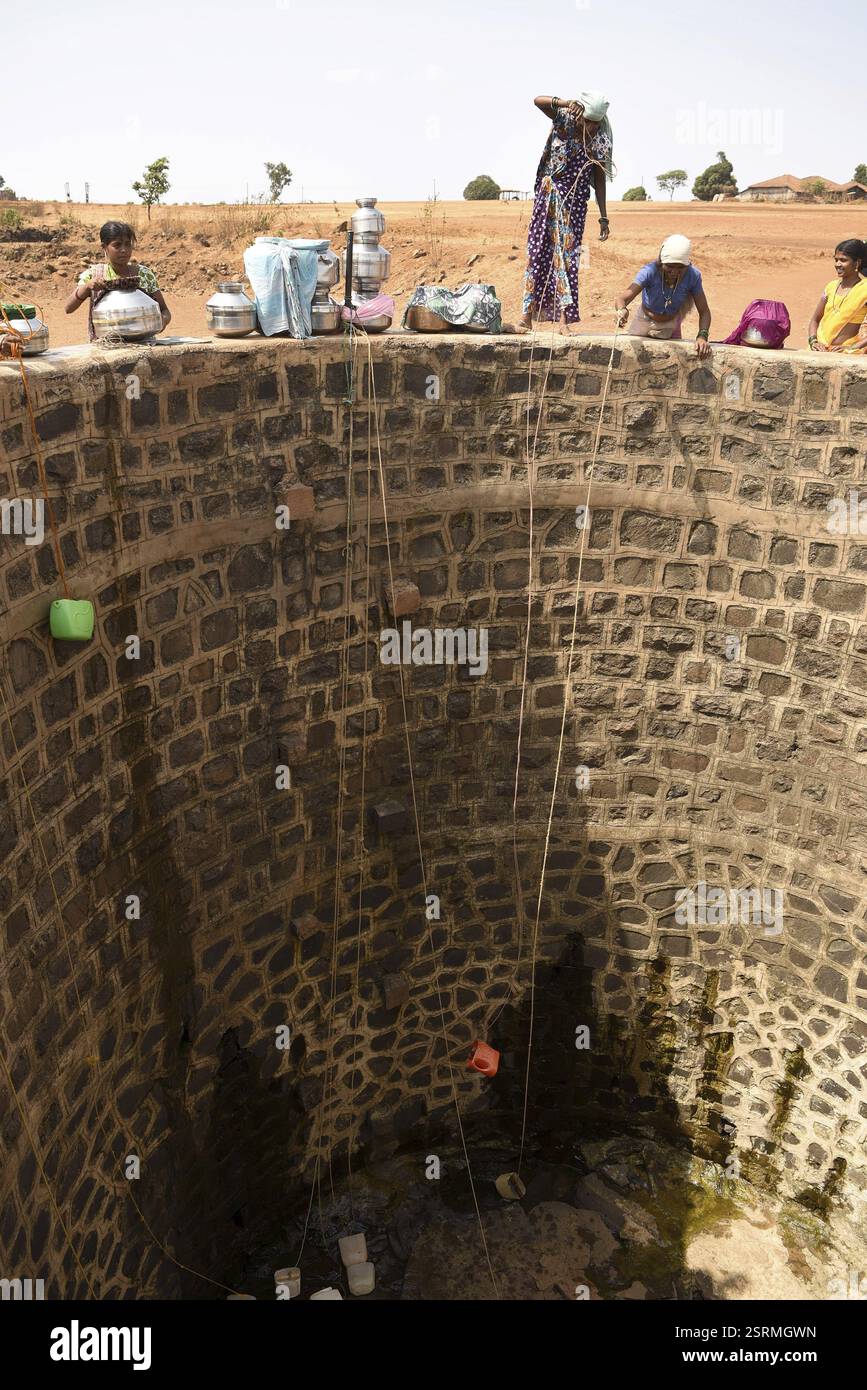 Women collecting water from well at Mal village, Shahapur Thane ...