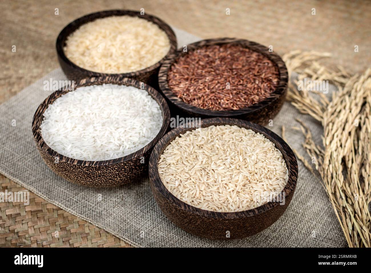 different kinds of asian rice grains in rustic setting display in ...