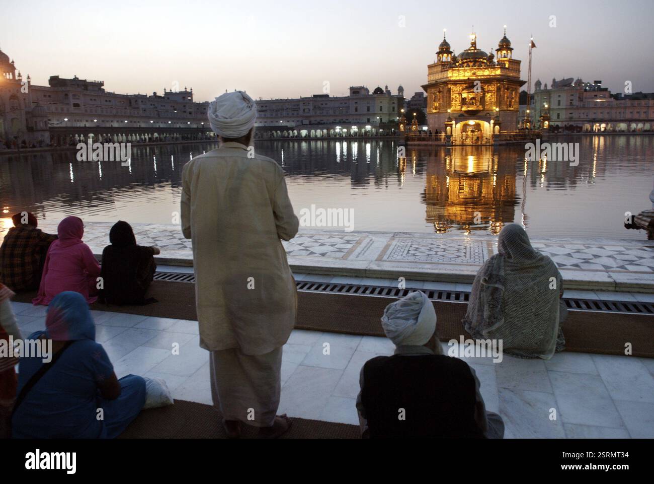 Devotees praying in front of Sri Harimandir Darbar Sahib or Golden ...