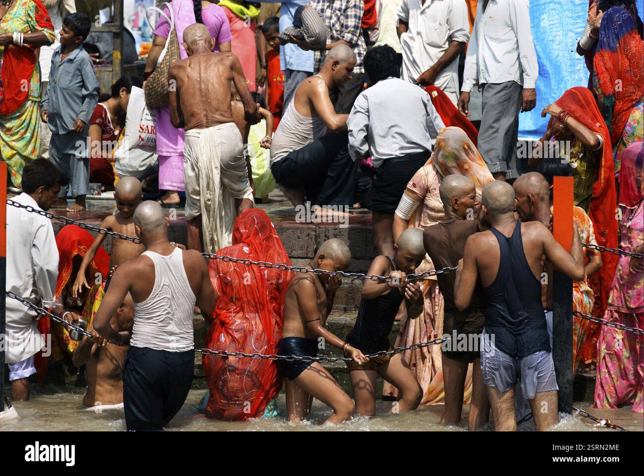 Devotees on riverbank ghats of river ganga ganges taking holy dip at ...