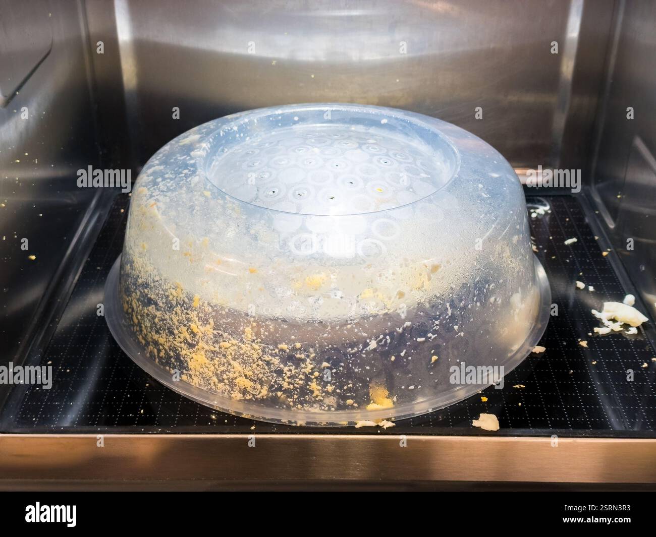 Dirty microwave cover after exploded egg, kitchen cleaning concept ...