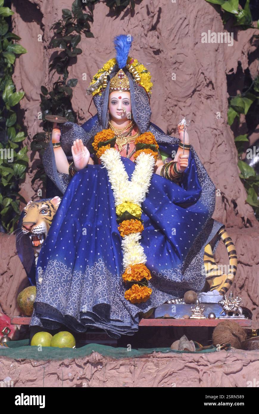 Richly decorated idol of goddess Durga riding on tiger for Navaratri ...