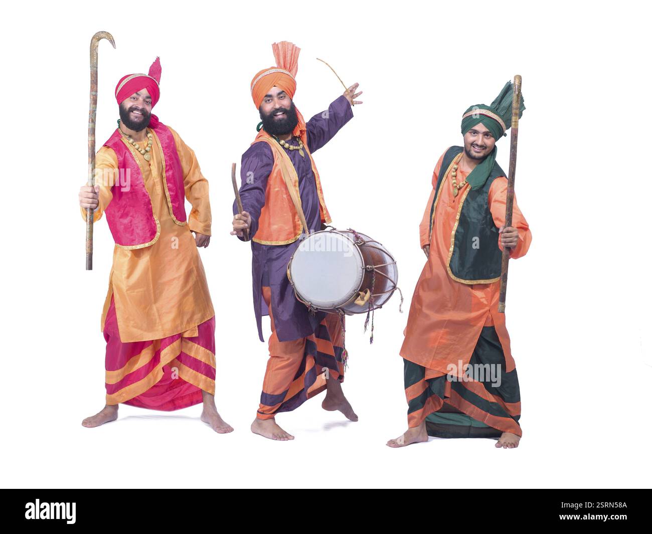 Dancers playing musical instrument dholak performing folk dance bhangra ...