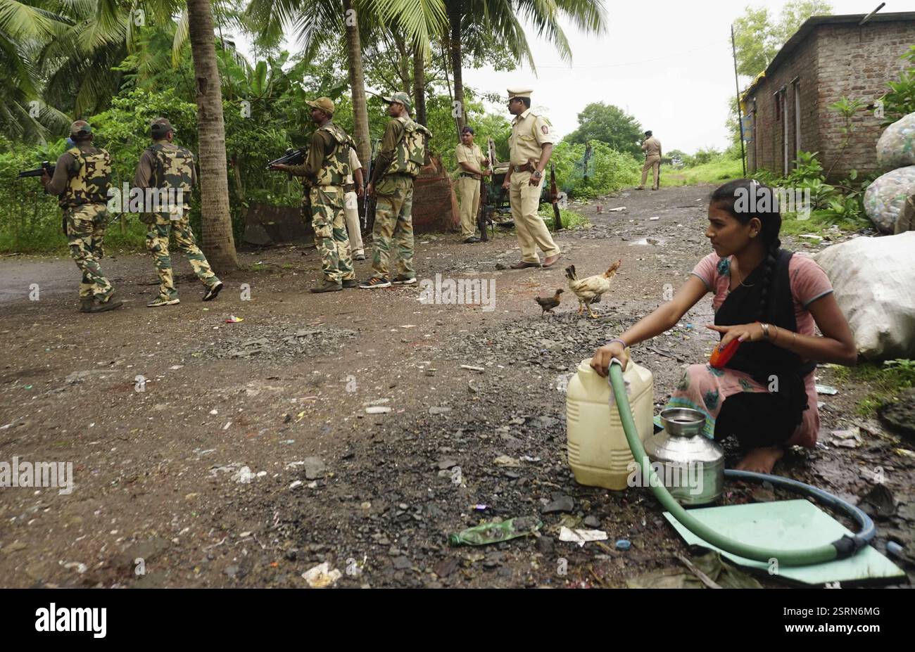 Woman collects ground water Force One commandos conduct search combing operation slum area of ...