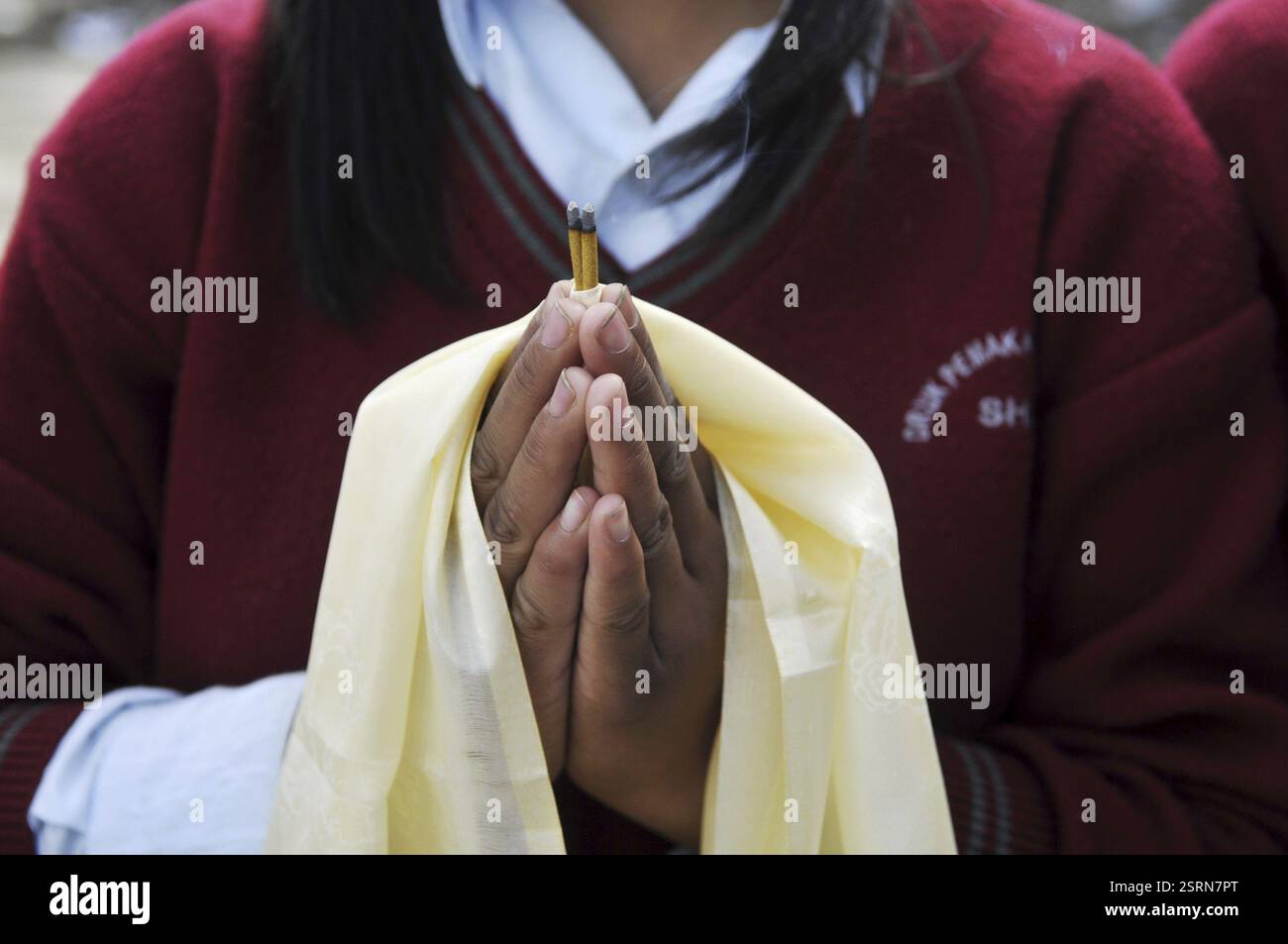 Buddhist student welcome guest holding incense stick, Shey, Leh, Ladakh ...
