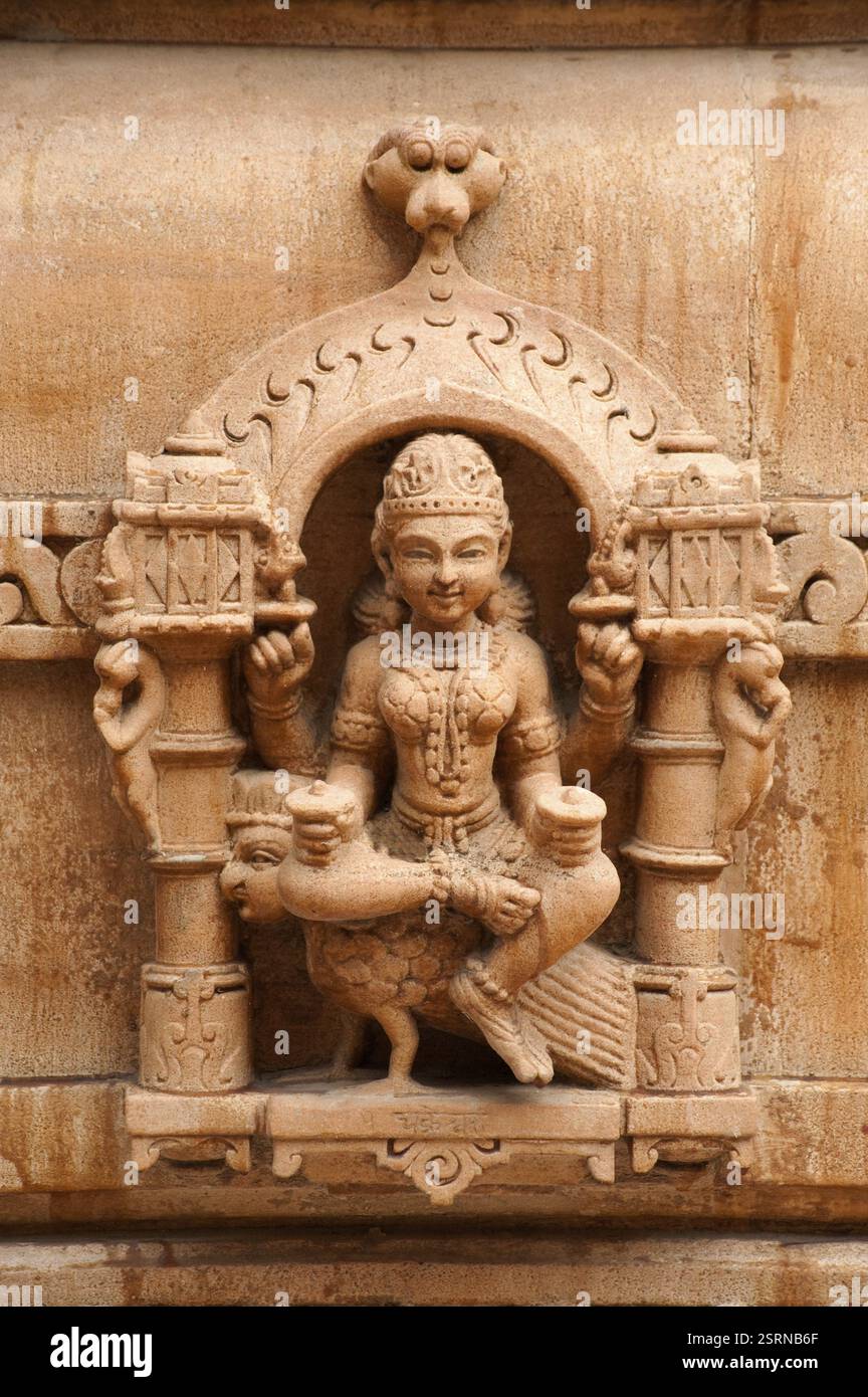Sculpture of goddess chakreshwari sitting on a eagle on the wall of ...