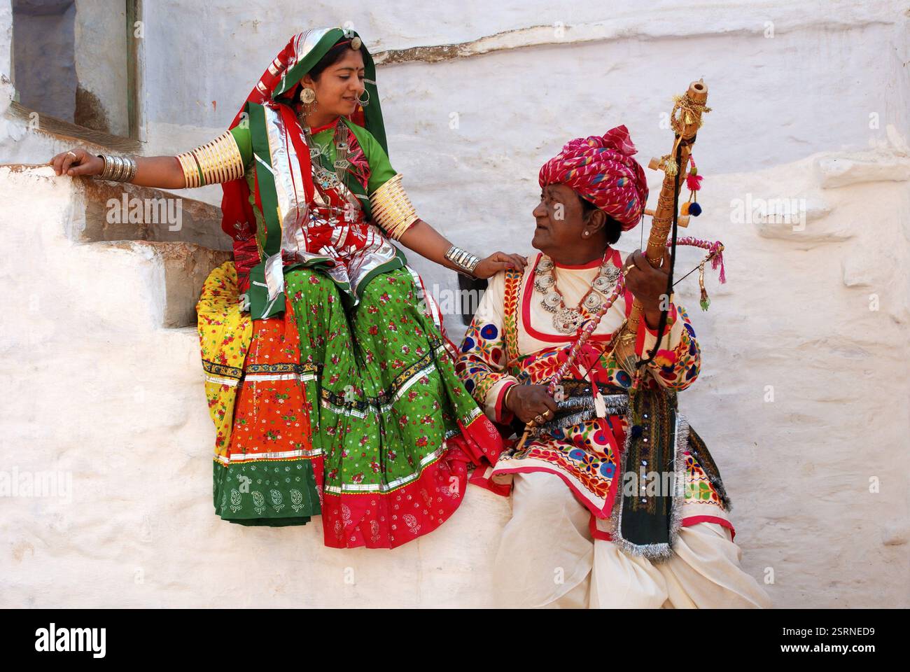 Rajasthani folk musician playing ravanhatta with lady in romantic mood ...