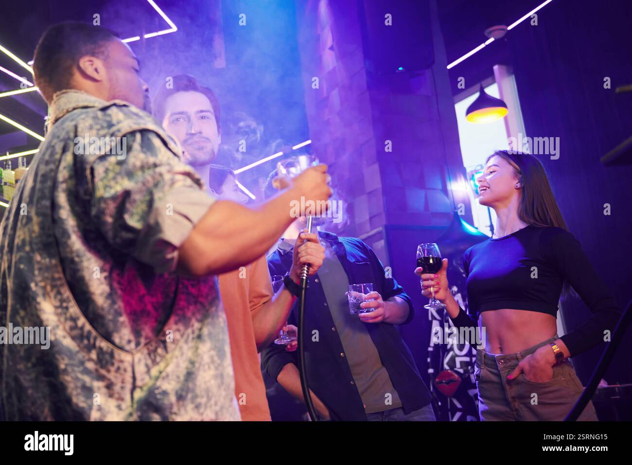 Talking with each other. Group of friends having fun in the night club ...