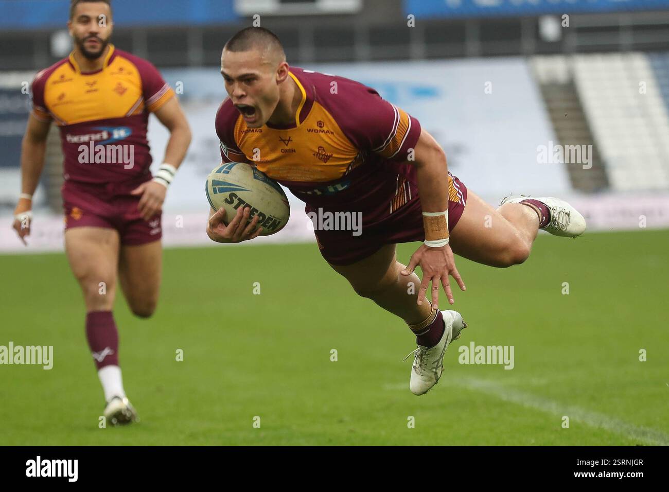Tui Lolohea dives in fir a try for Huddersfield *** during the Super ...
