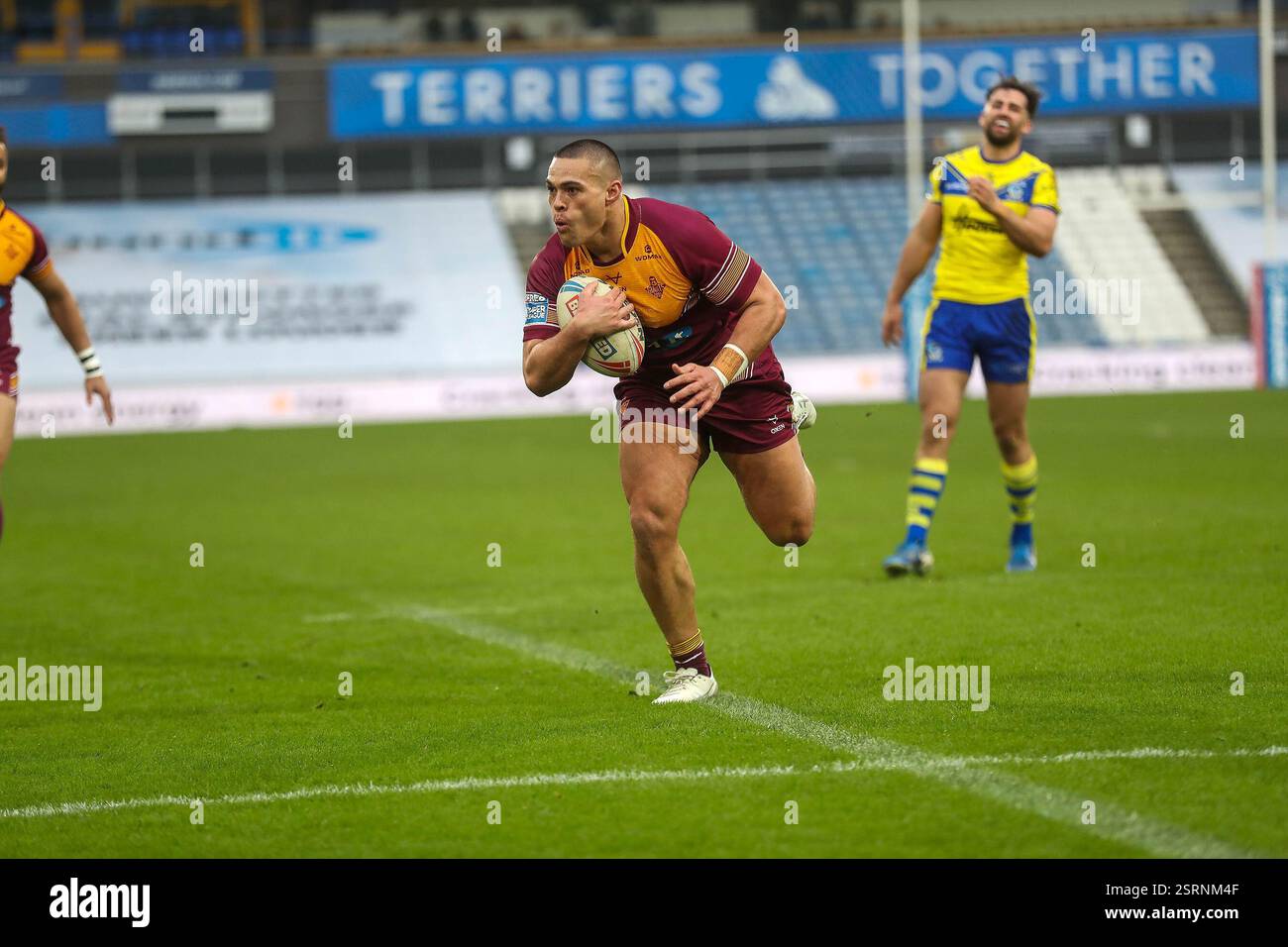 Tui Lolohea on his way to a try *** during the Super League match between Huddersfield Giants ...