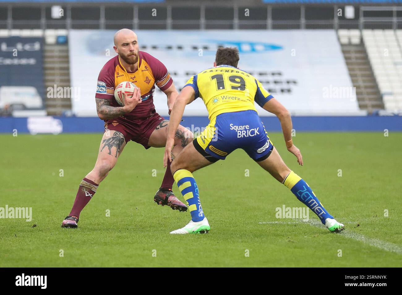 Jake Bibby runs at the Warrington defence *** during the Super League ...
