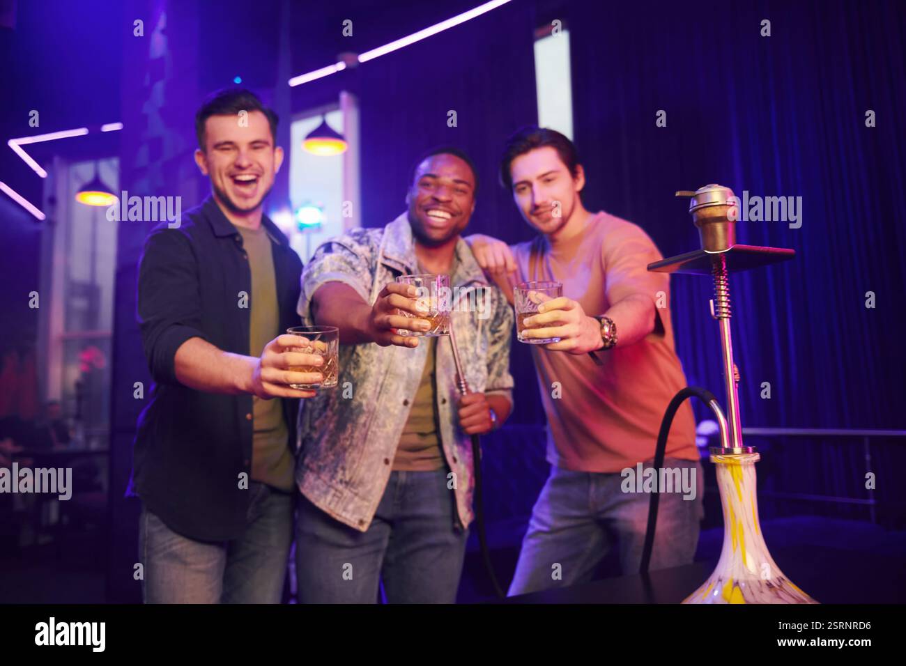 Partying all night long. Group of friends having fun in the night club ...