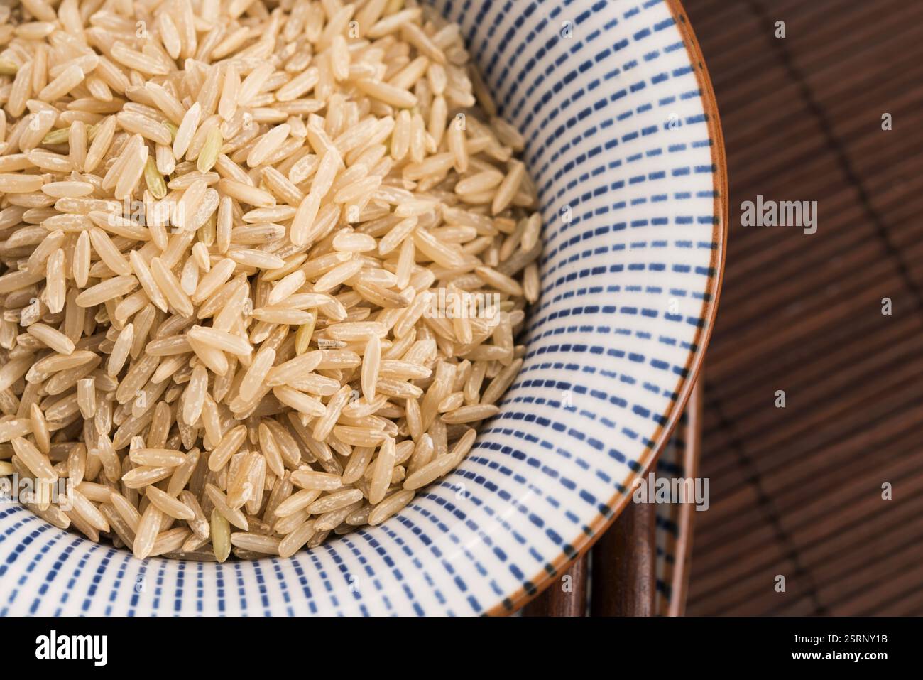 Raw brown rice in a bowl Stock Photo - Alamy