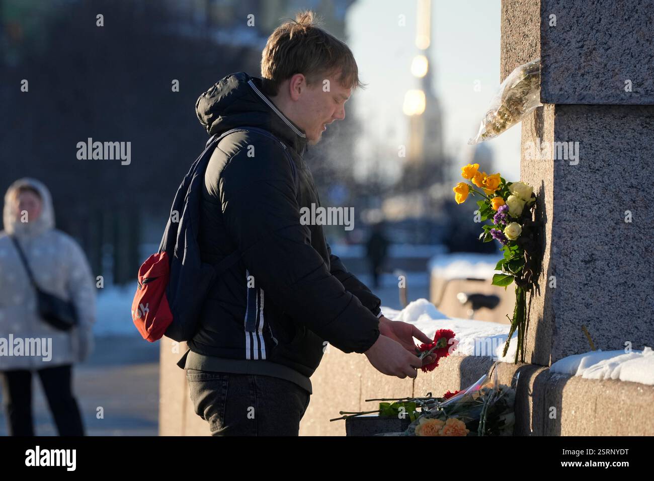 A man lays flowers in memory of Russian opposition leader Alexei ...