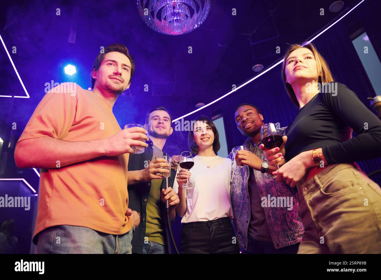 Having a party. Group of friends in the night club together Stock Photo ...