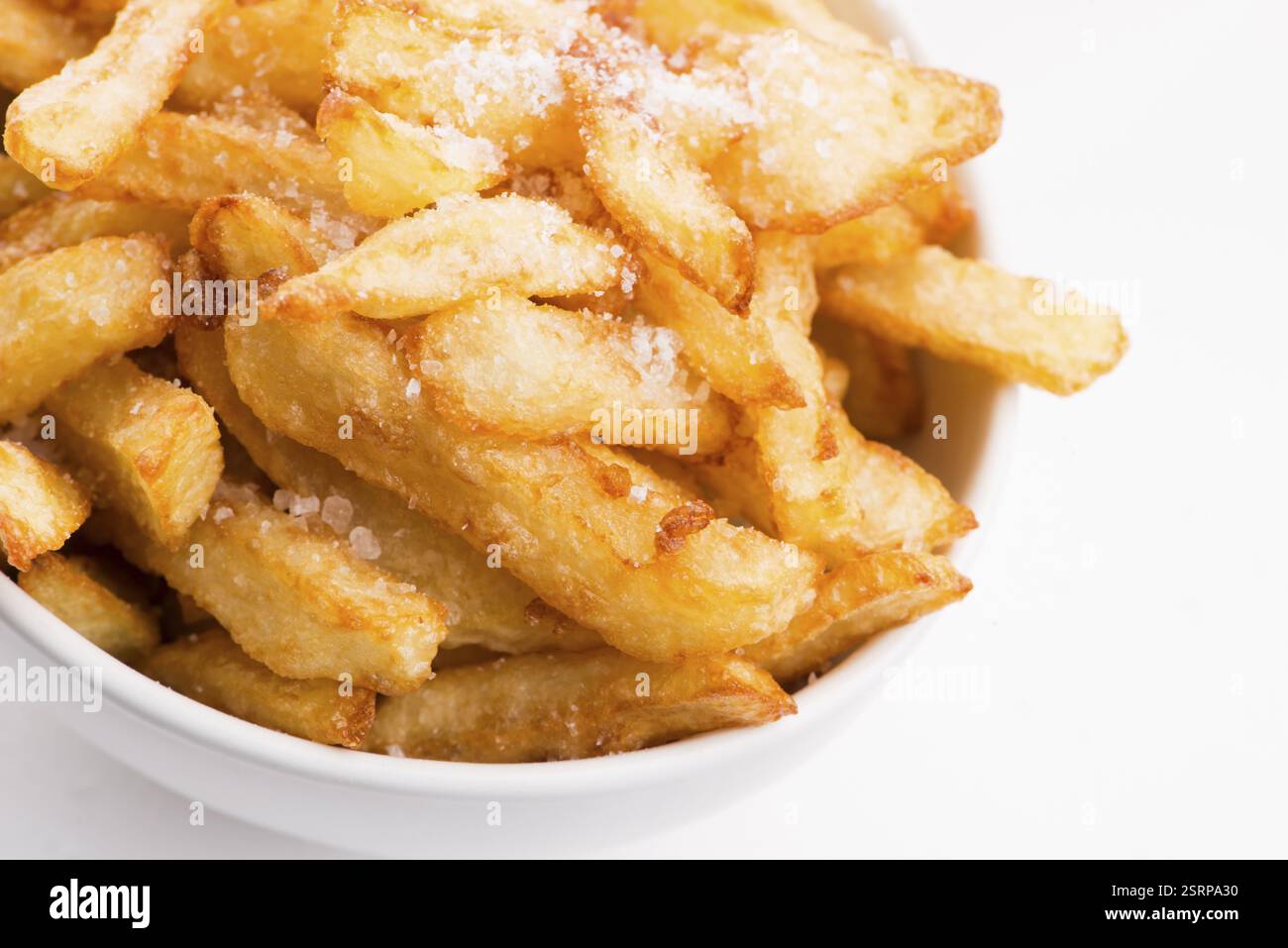 Bowl of potatoe fries on a white background Stock Photo - Alamy