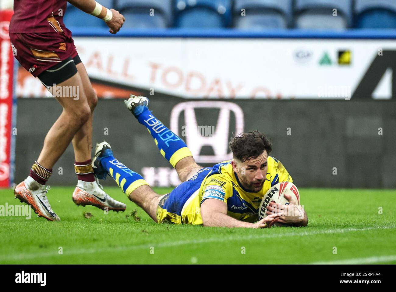 Toby King of Warrington Wolves goes over for a try during the Betfred ...