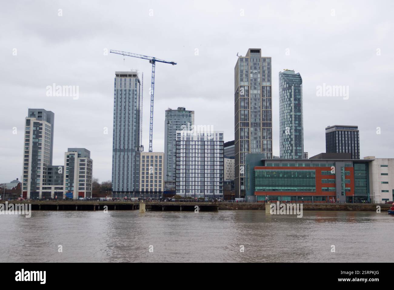 Modern skyscrapers and tower blocks line the banks of the River Mersey ...