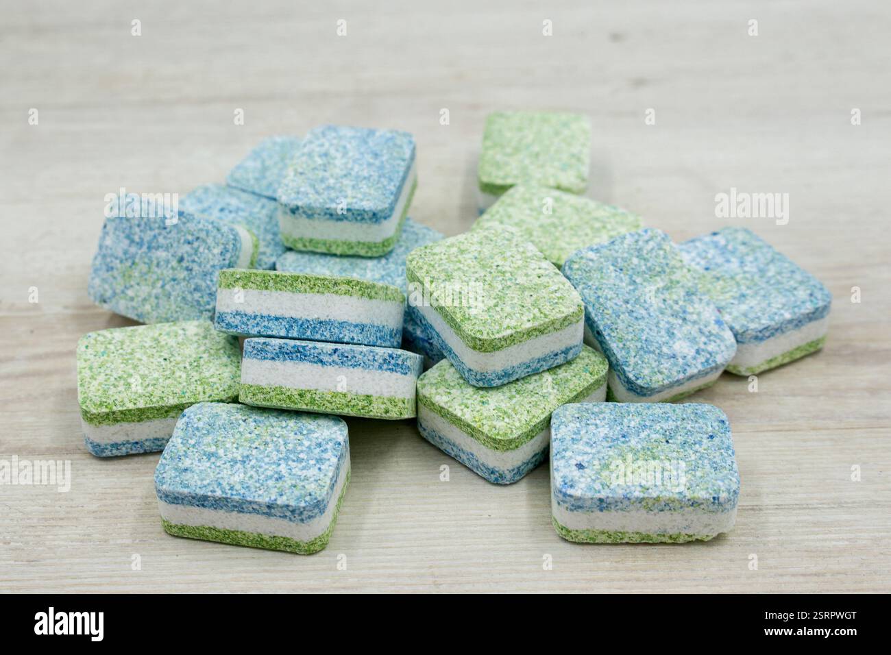 Dishwasher tablets on colored background. Three-layer rectangular ...