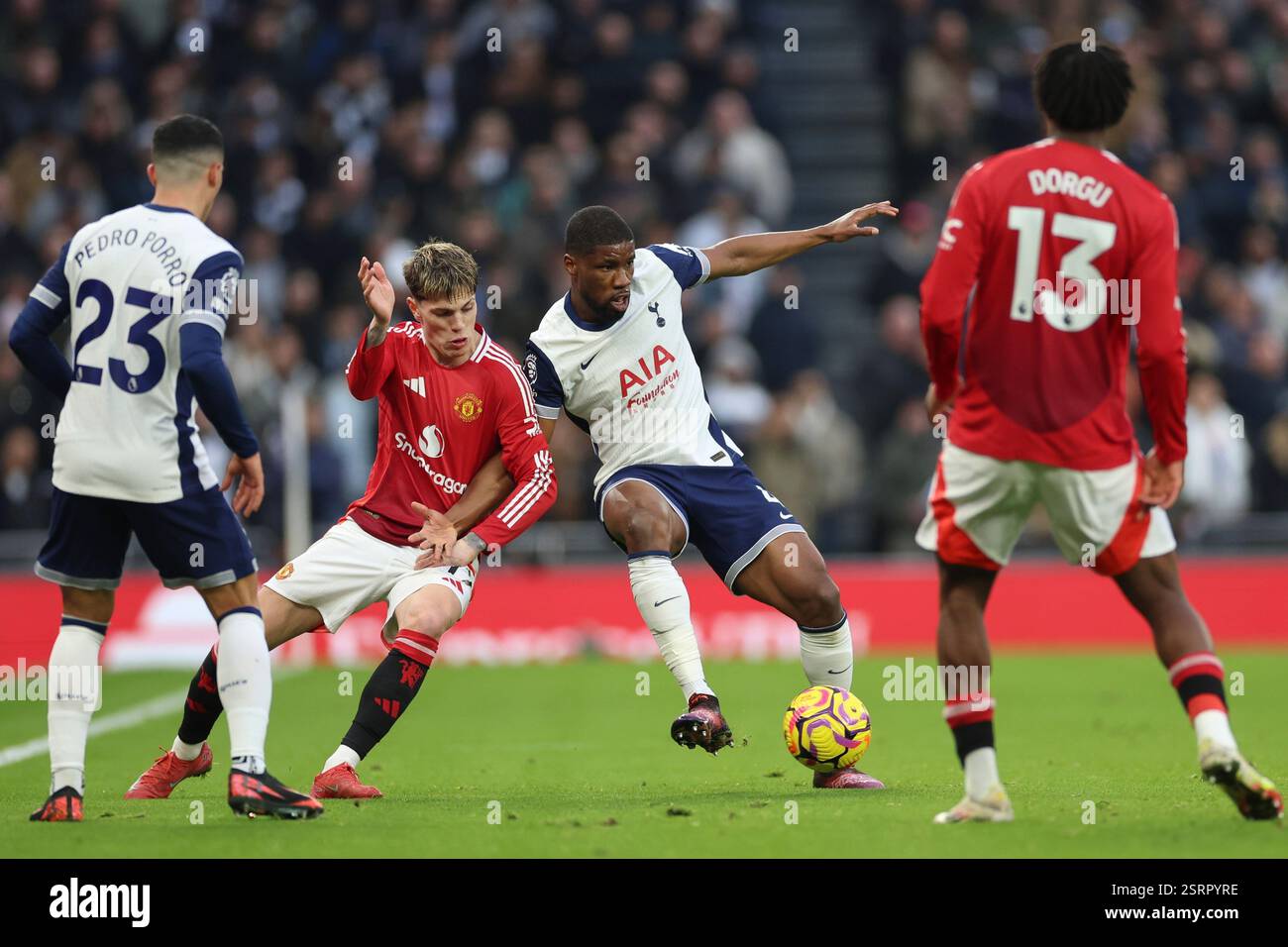 Manchester United's Alejandro Garnacho, left, challenges Tottenham's ...