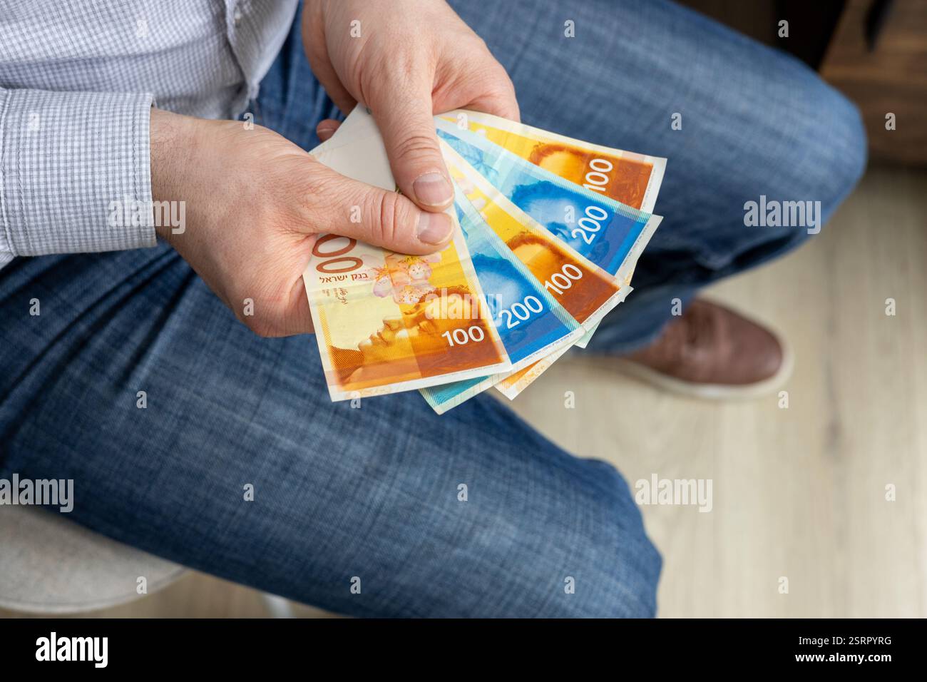 Businessman israeli shekel money hi-res stock photography and images ...
